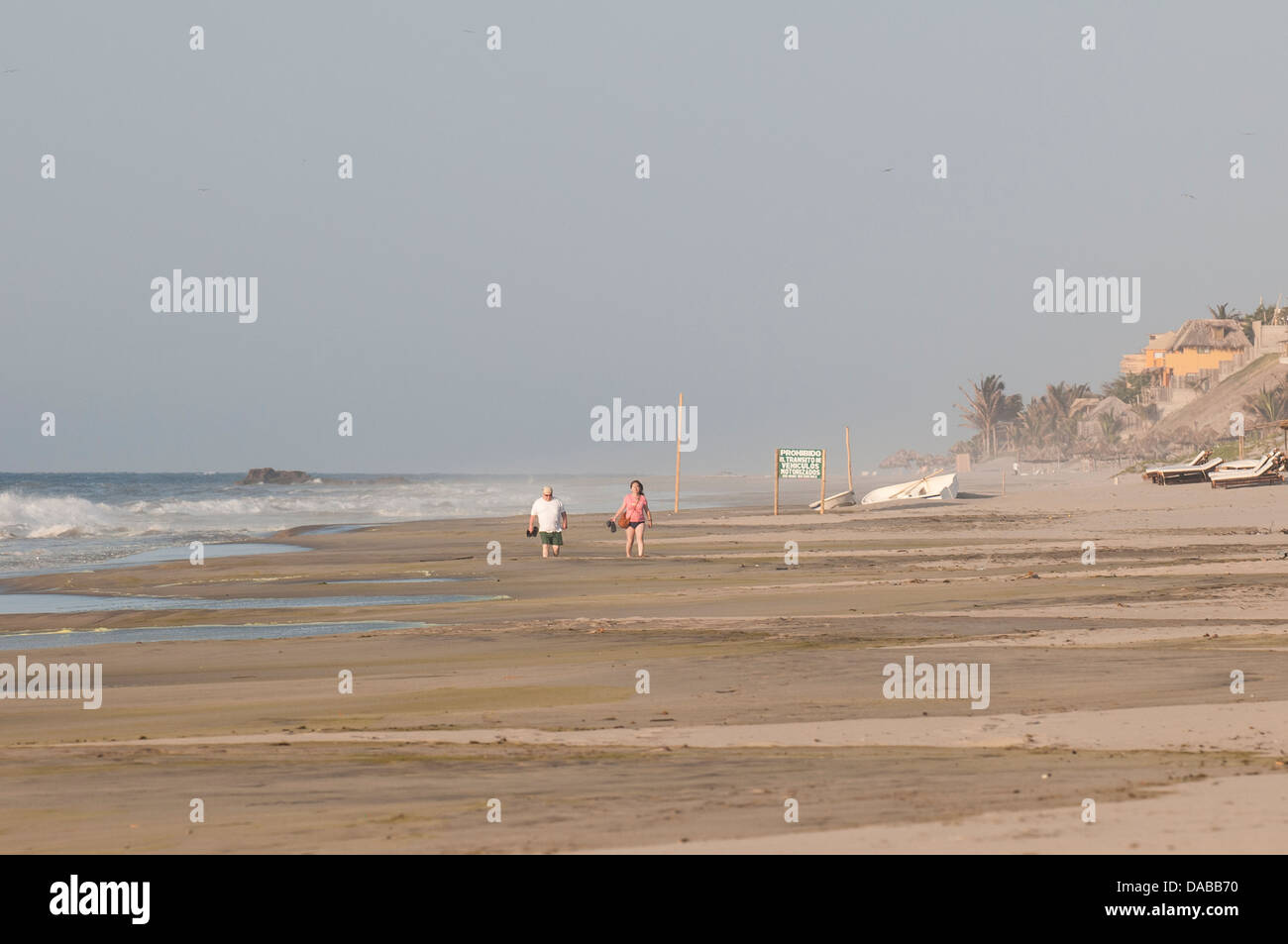 Couple taking a romantic walk on Vichayito beach at sunset, Mancora ...