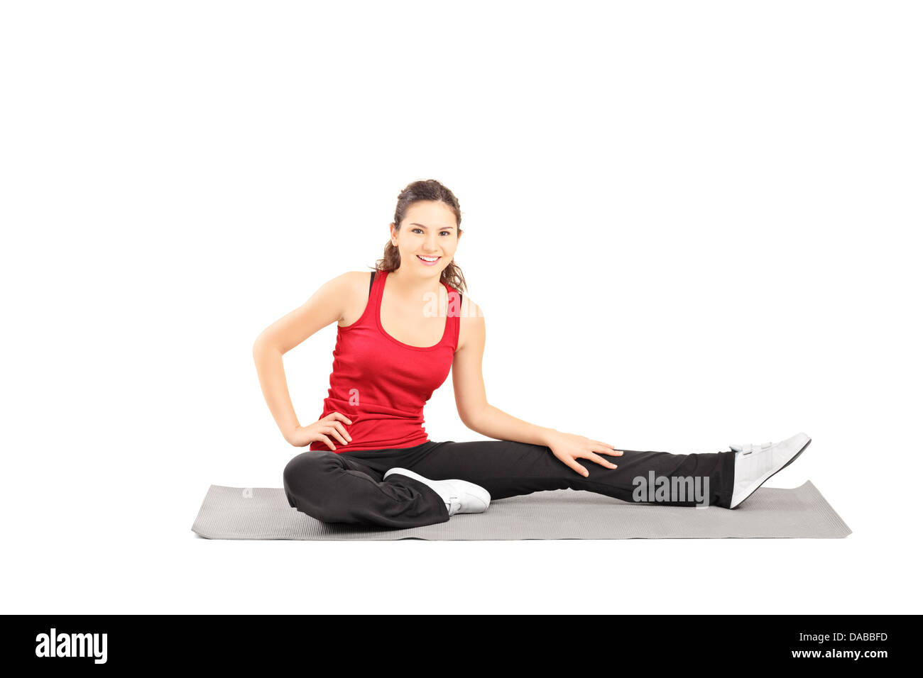 Young active female posing on a mat Stock Photo - Alamy