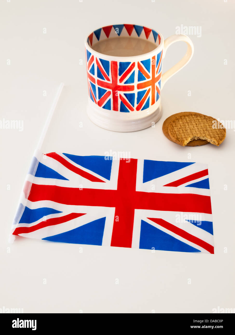 A cup of milky english tea in a british union jack mug with digestive ...