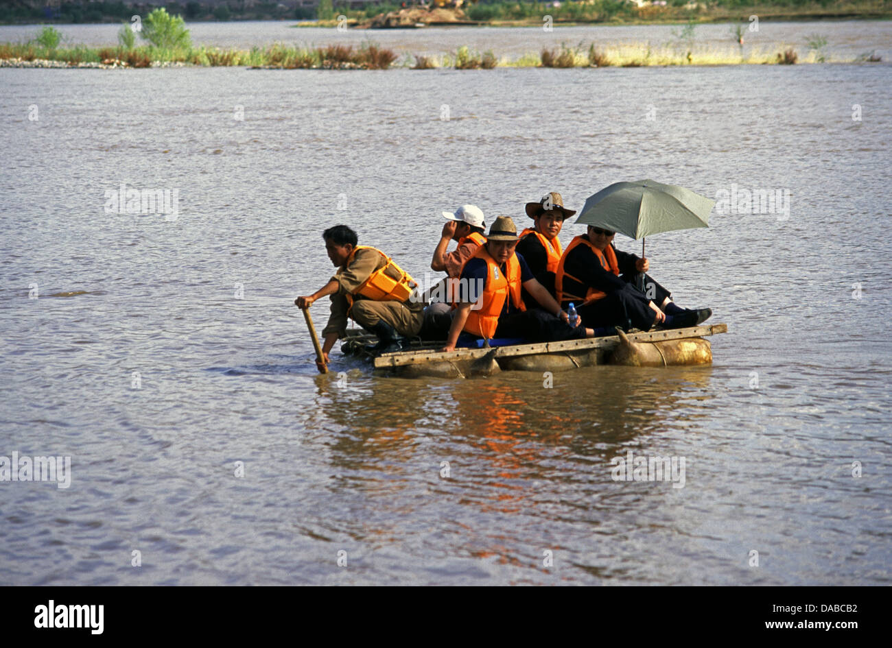 Chinese men rowing in a raft made from inflated sheepskin lashed to a ...