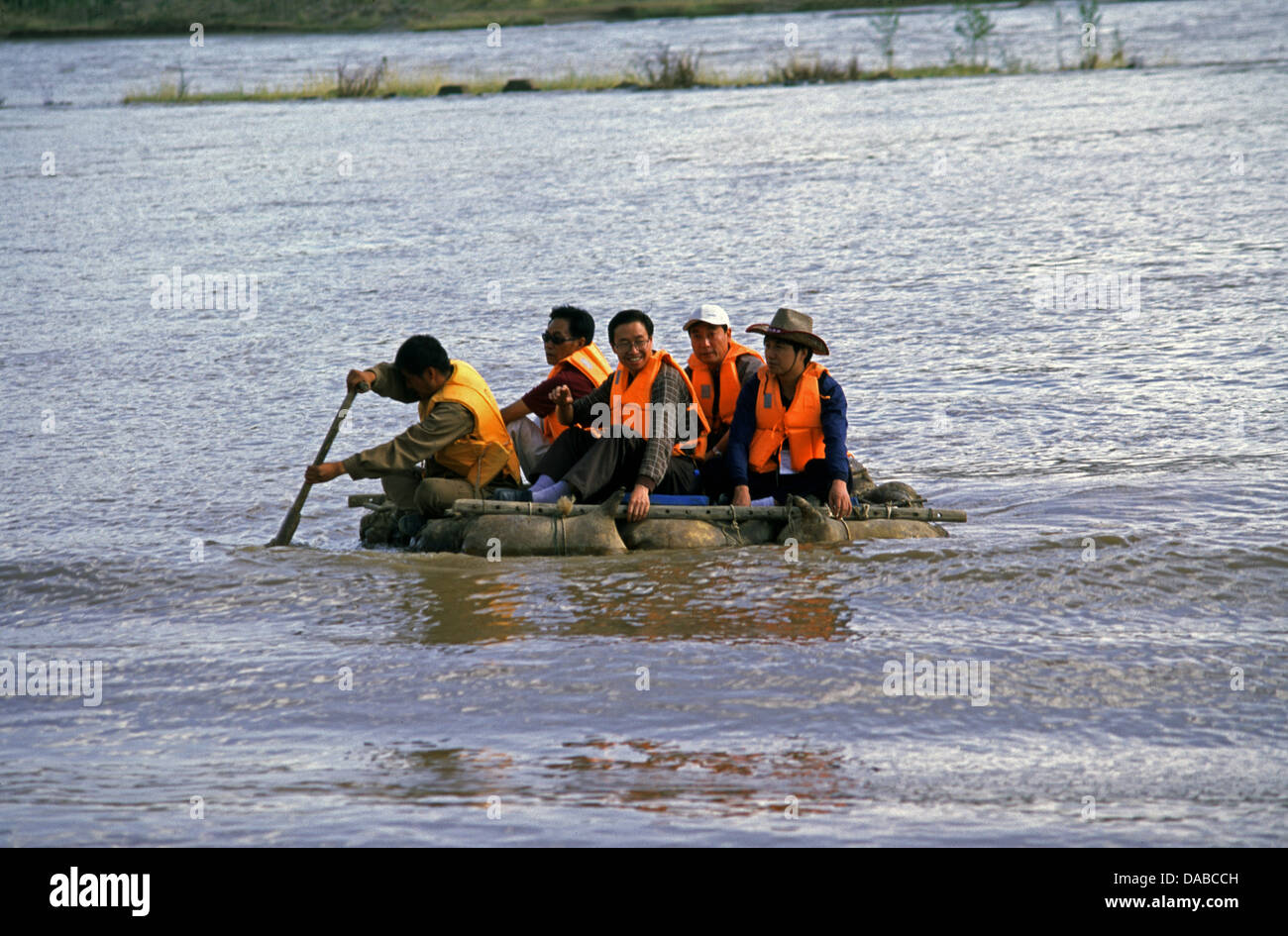 Chinese men rowing in a raft made from inflated sheepskin lashed to a ...