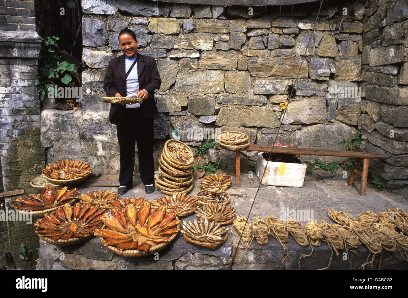 A Chinese fishmonger selling salted and dried fish in the Tujia ...