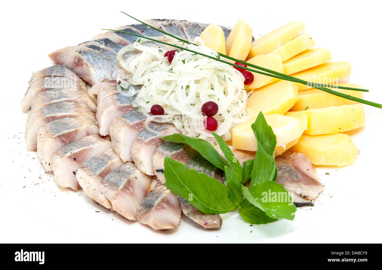 a plate of herring on a white background Stock Photo - Alamy