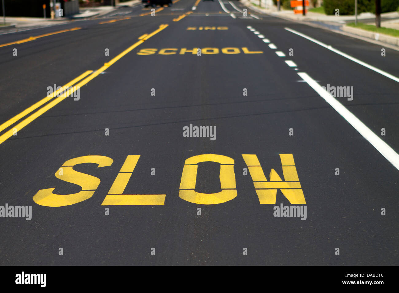 road markings at school crossing in America warning drivers to slow ...