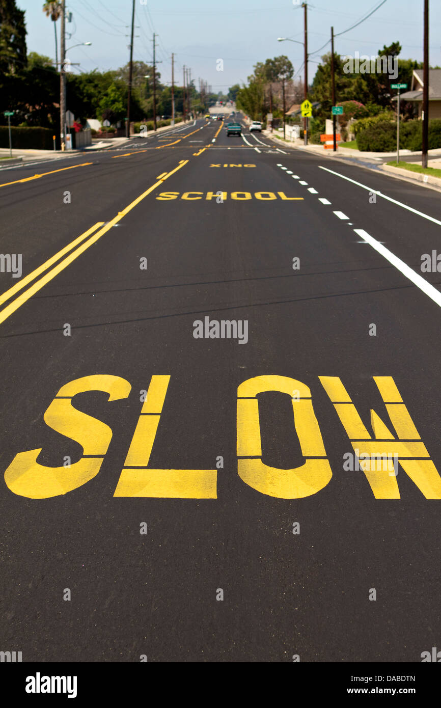 road markings at school crossing in America warning drivers to slow ...