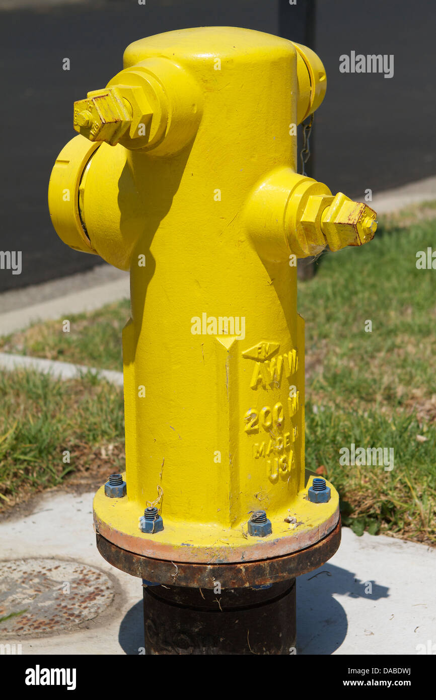 A yellow American fire hydrant at the side of the road Stock Photo - Alamy