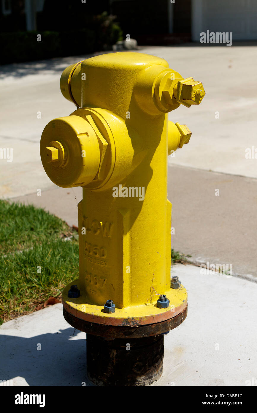 A yellow American fire hydrant at the side of the road Stock Photo - Alamy