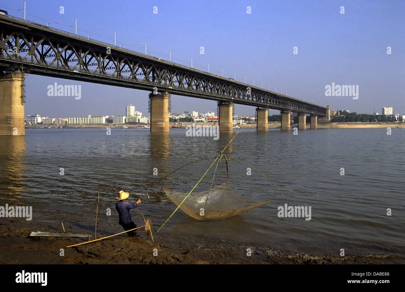 Traditional net fishing beneath the Wuhan Yangtze Great Bridge across ...