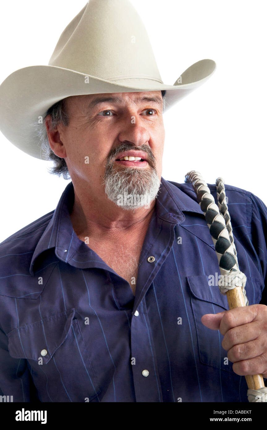 Cowboy holding a bullwhip around his shoulder. Isolated on white Stock ...
