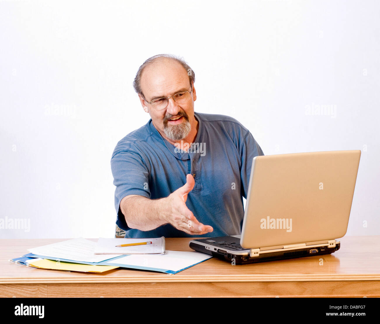 Businessman reaching to shake the hand of a client across his desk ...