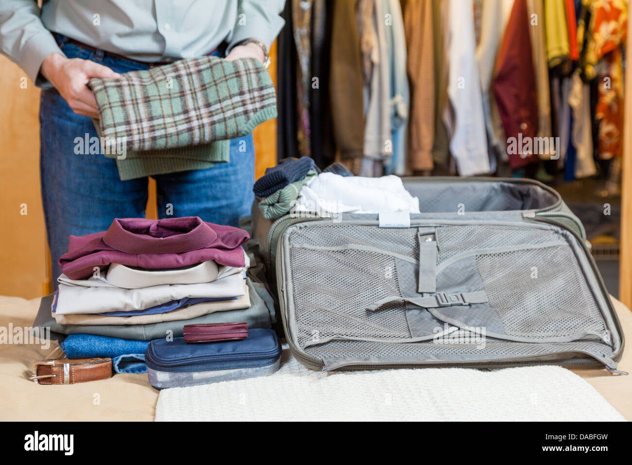 Man packing clothes hi-res stock photography and images - Alamy
