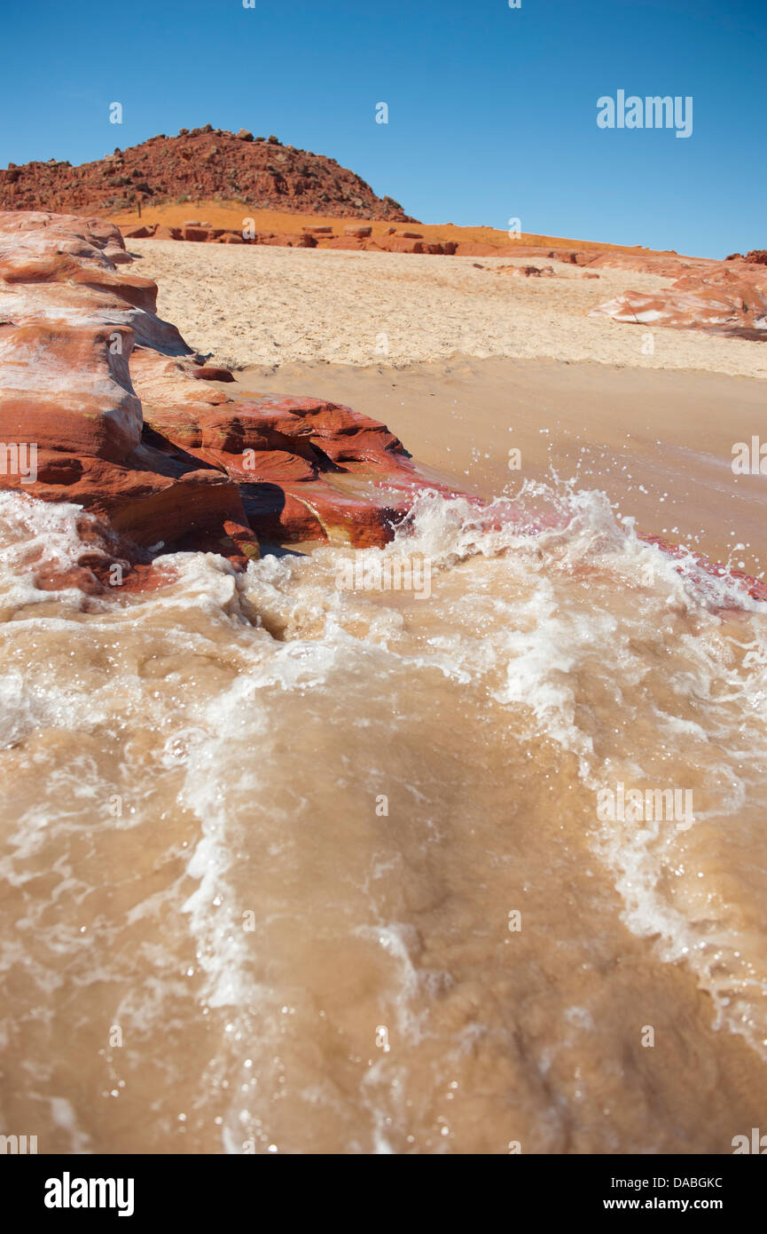 The eroded red sandstone cliffs of the Western Beach of Cape Leveque ...