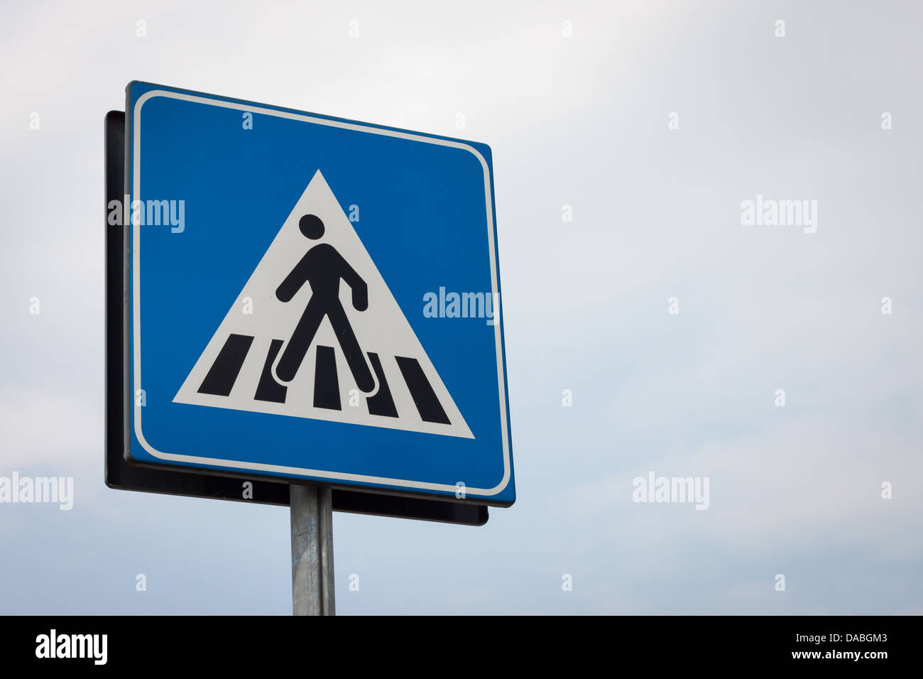 Blue road sign symbol of pedestrian crossing Stock Photo - Alamy