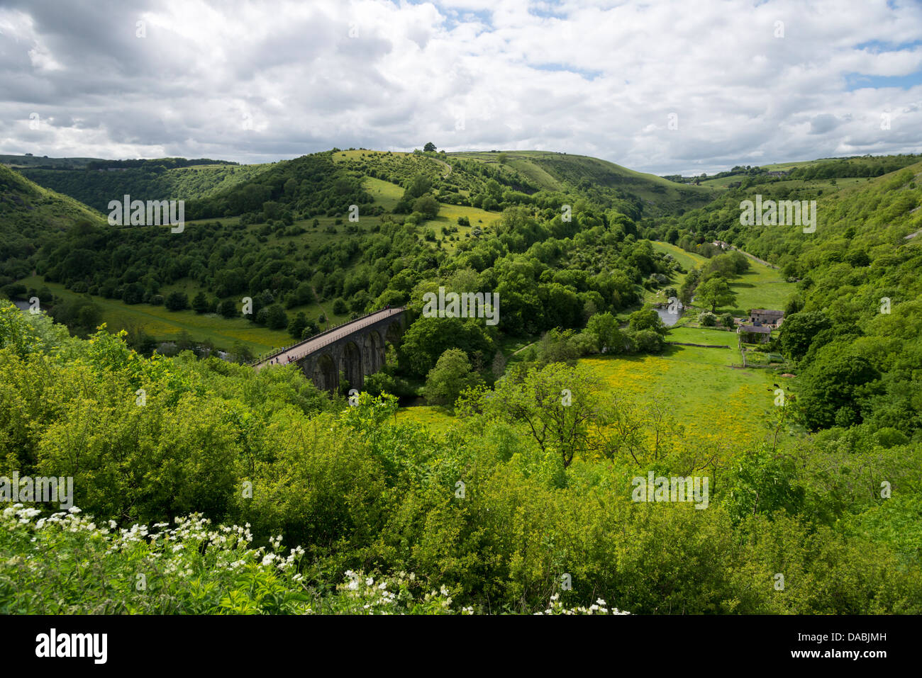 Lush green countryside of Monsal Dale and viaduct in the Peak District ...