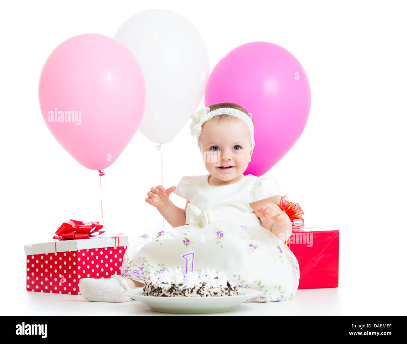 Joyful baby girl with cake, balloons and gifts. Isolated on white Stock ...