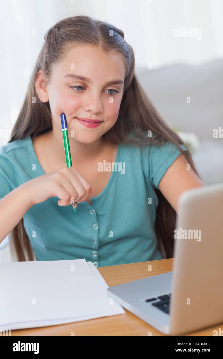 Smiling little girl doing her homework Stock Photo - Alamy