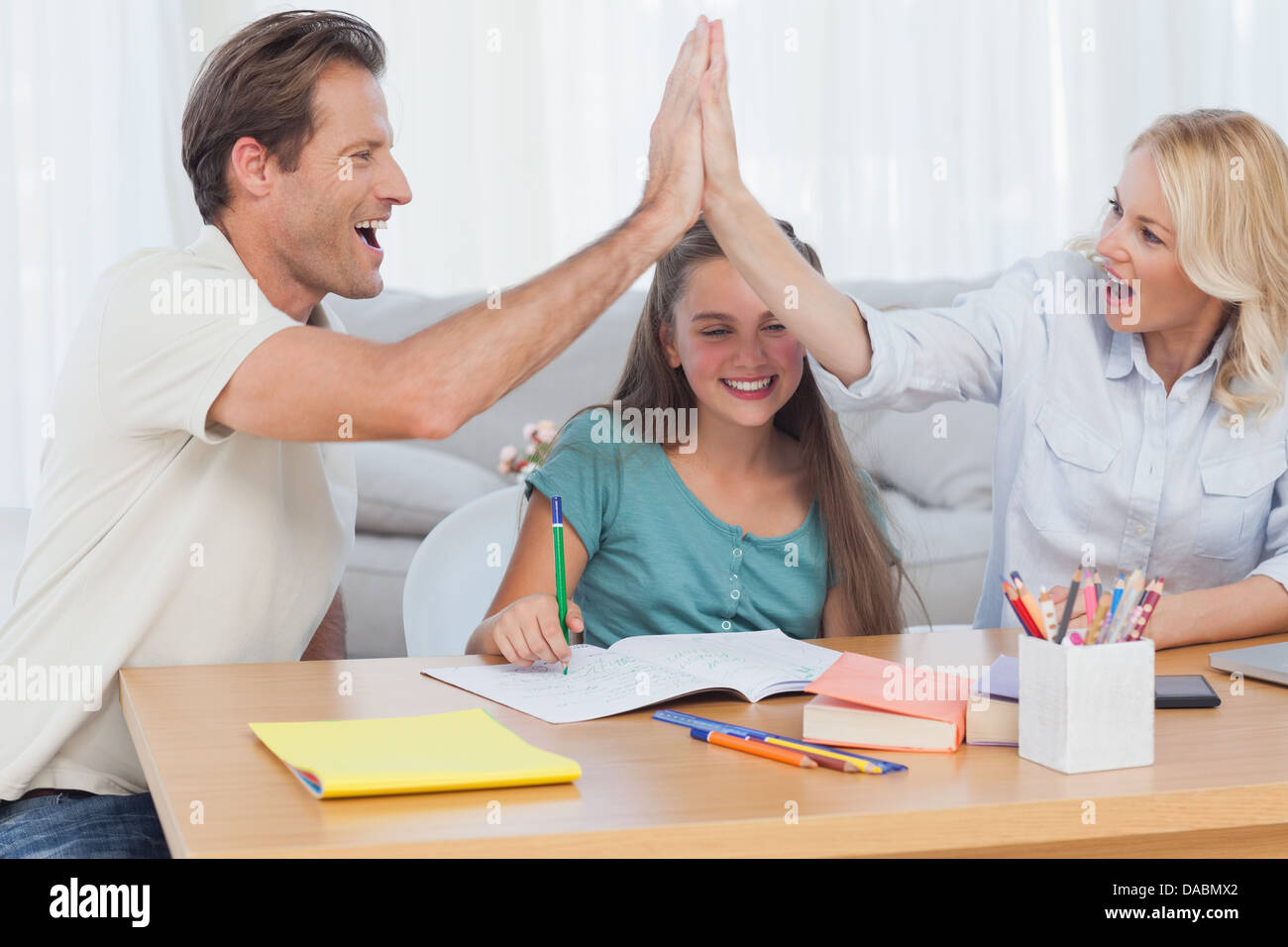Happy parents high fiving Stock Photo - Alamy