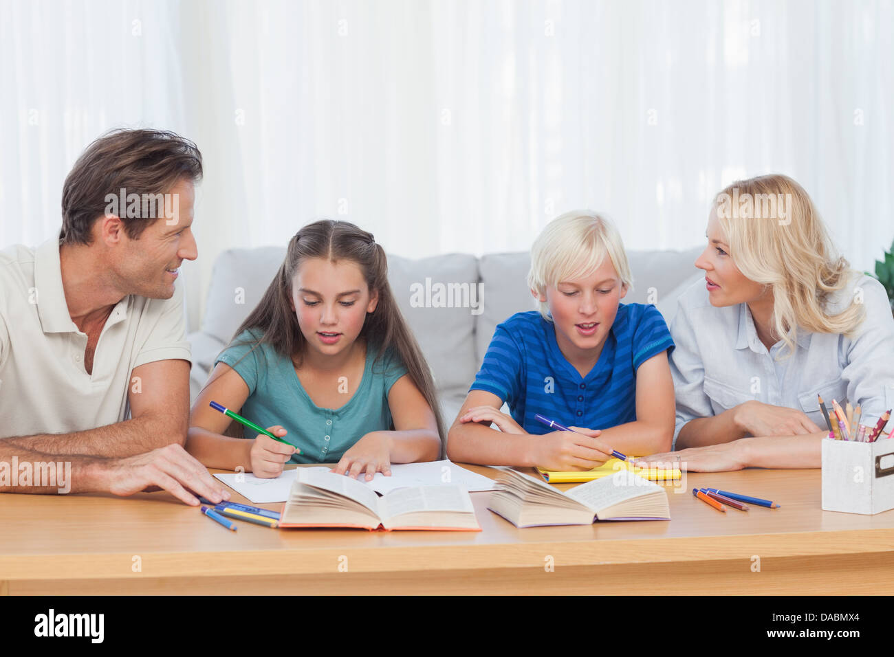 Parents helping their children doing their homework Stock Photo - Alamy