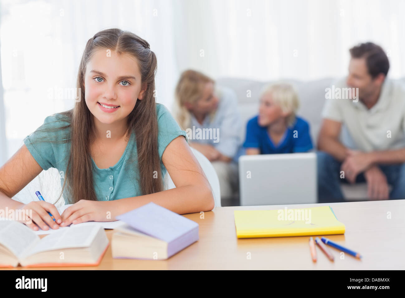 Smiling little girl doing her homework Stock Photo - Alamy