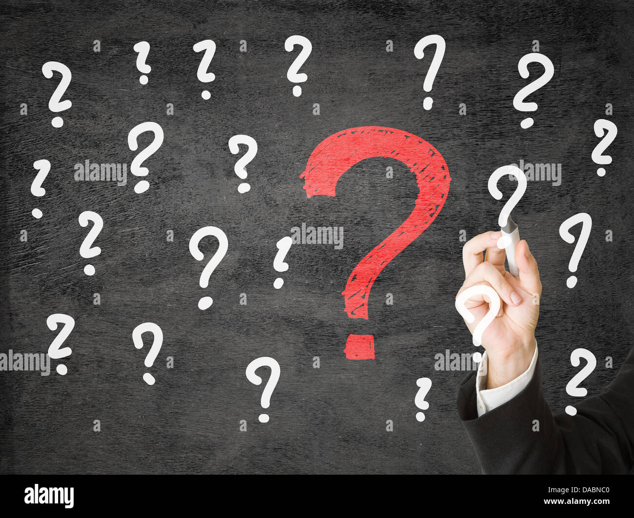 Businessman drawing question marks on transparent display Stock Photo ...