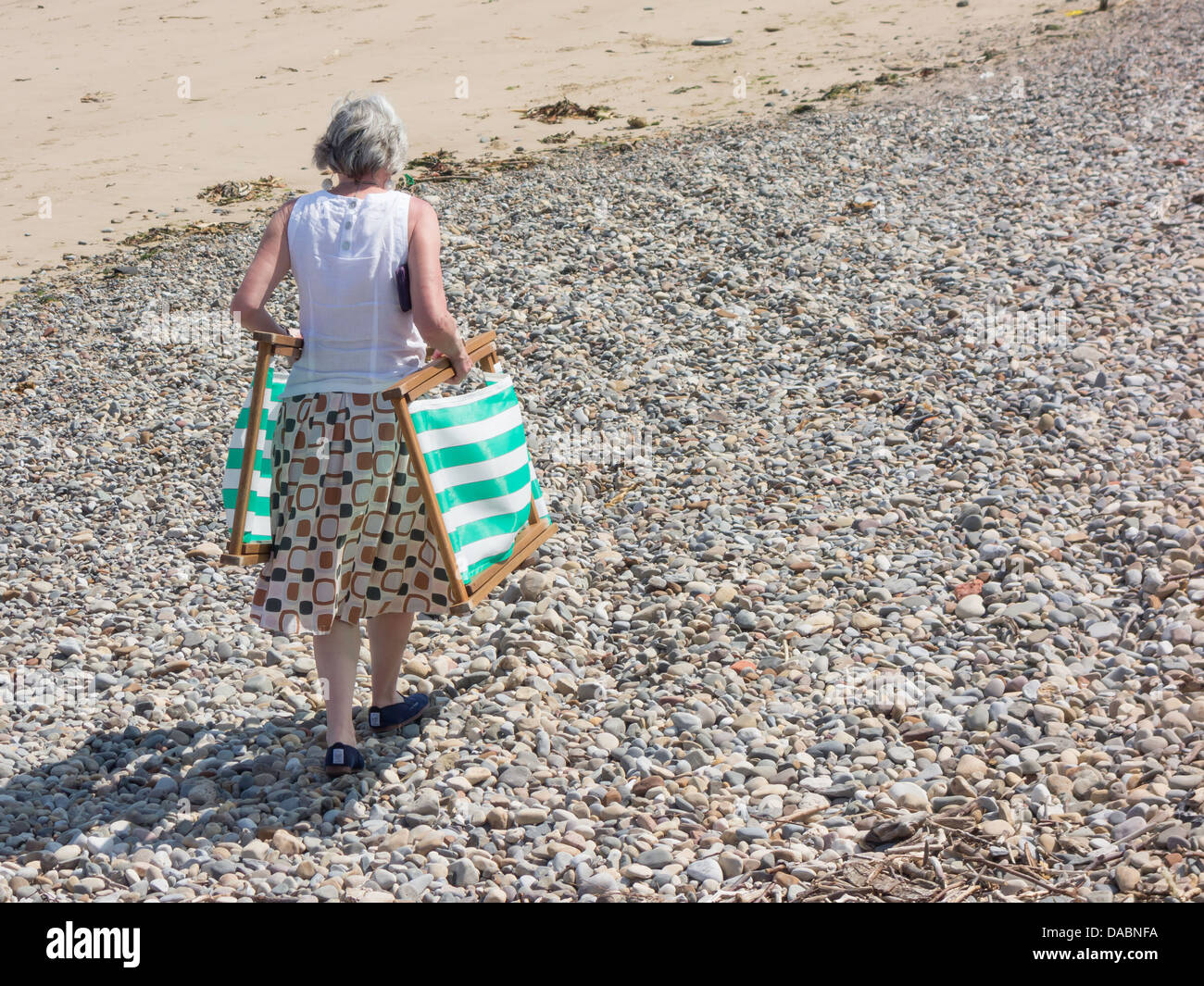 Carrying beach chairs hi-res stock photography and images - Alamy