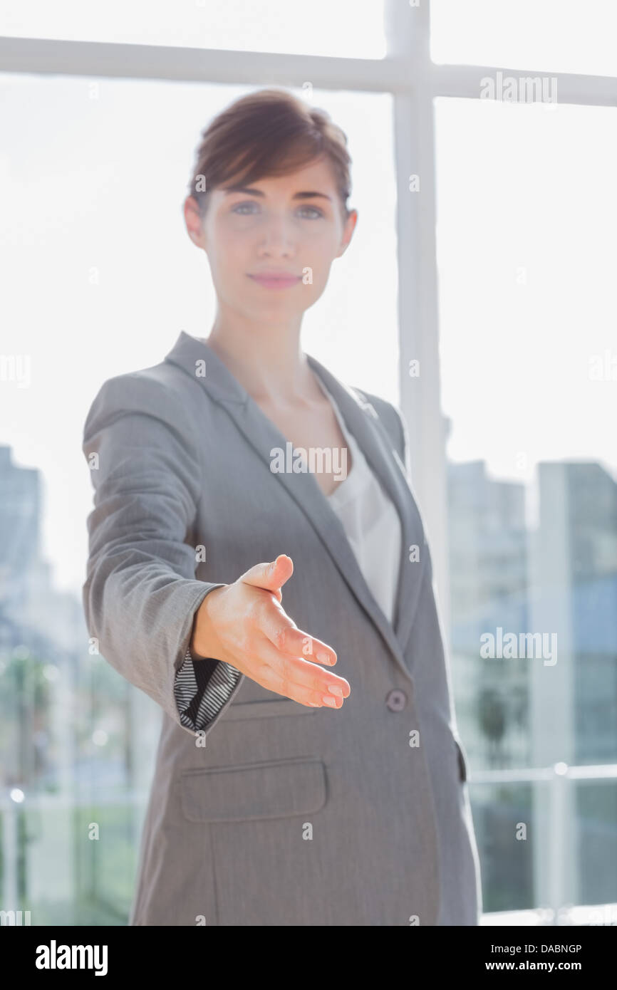Businesswoman reaching out greeting handshake hi-res stock photography ...