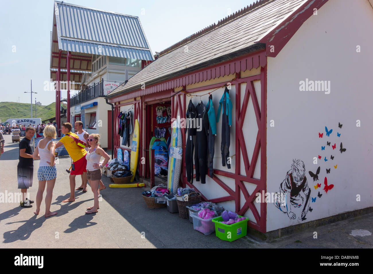 People talking outside the Surf Shop on the busy promenade at Saltburn ...