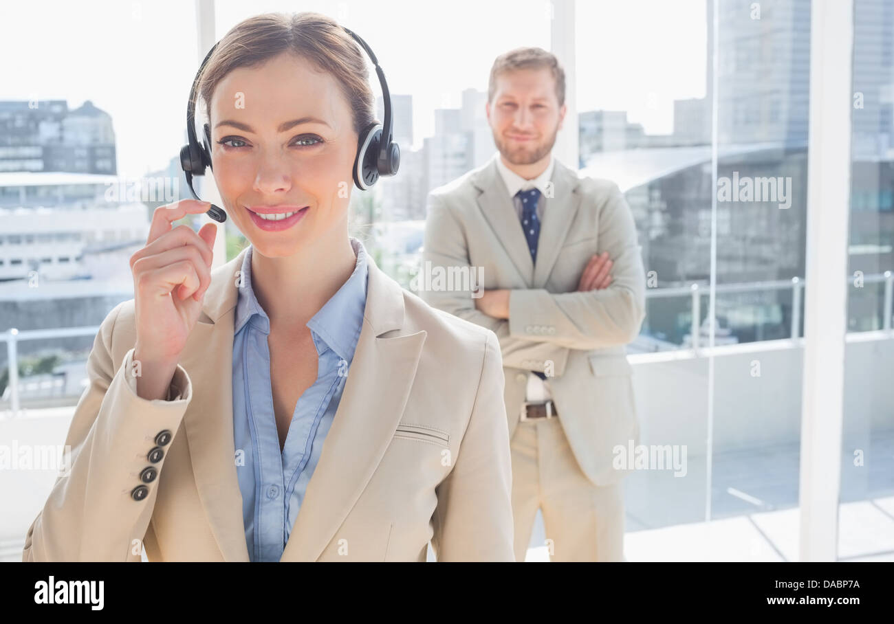 Call centre worker standing with colleague behind her Stock Photo - Alamy