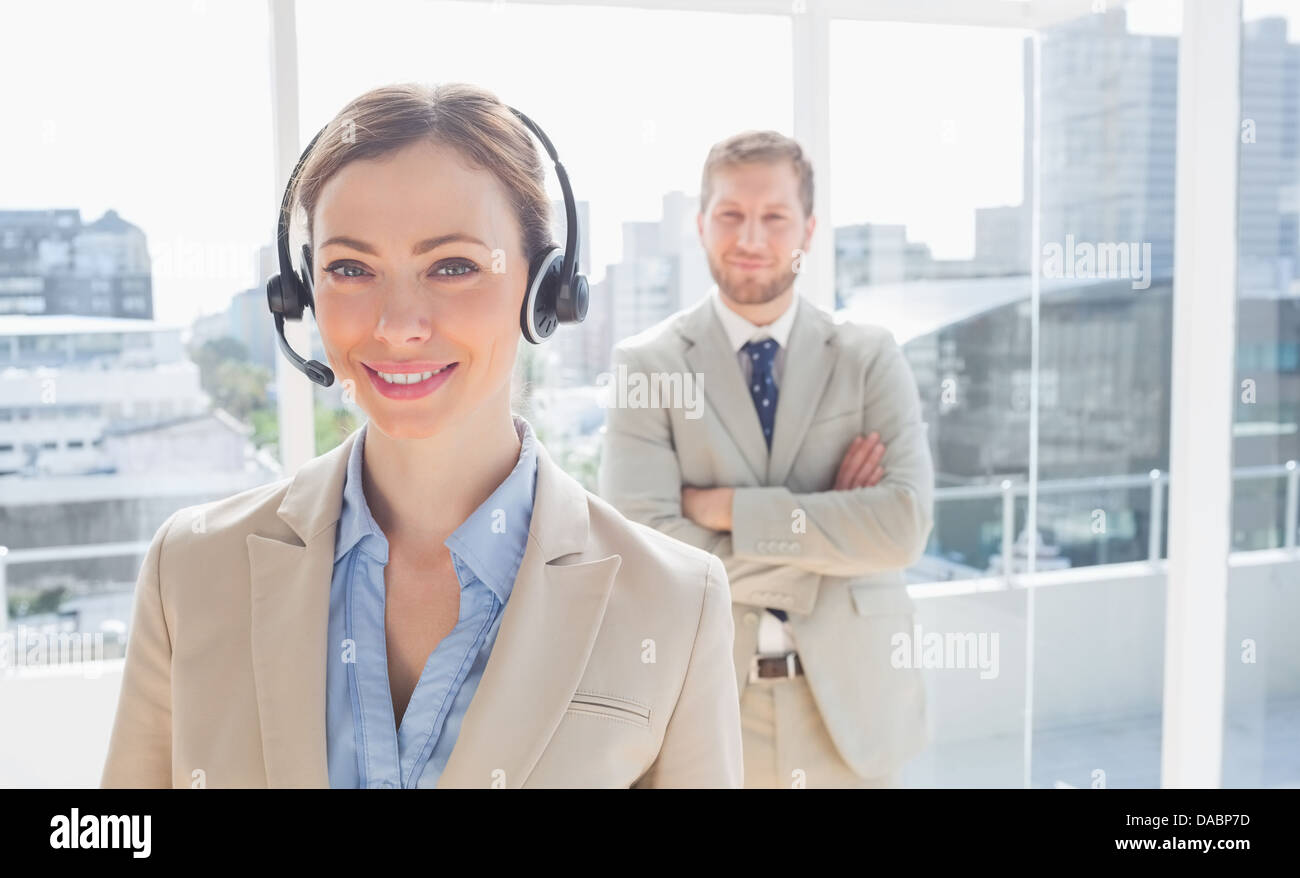 Call centre agent standing with colleague behind her Stock Photo - Alamy