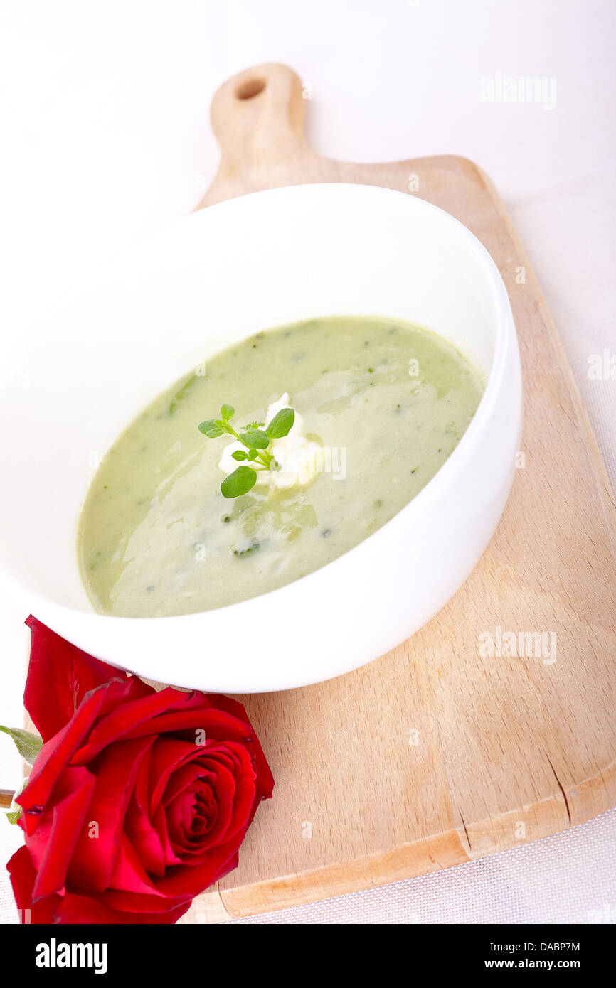 Green vegetable soup in a white bowl and red rose flower Stock Photo ...