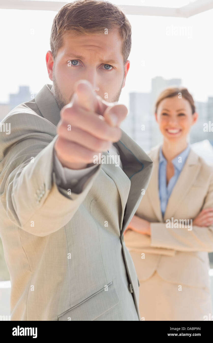 Annoyed businessman pointing at camera Stock Photo - Alamy