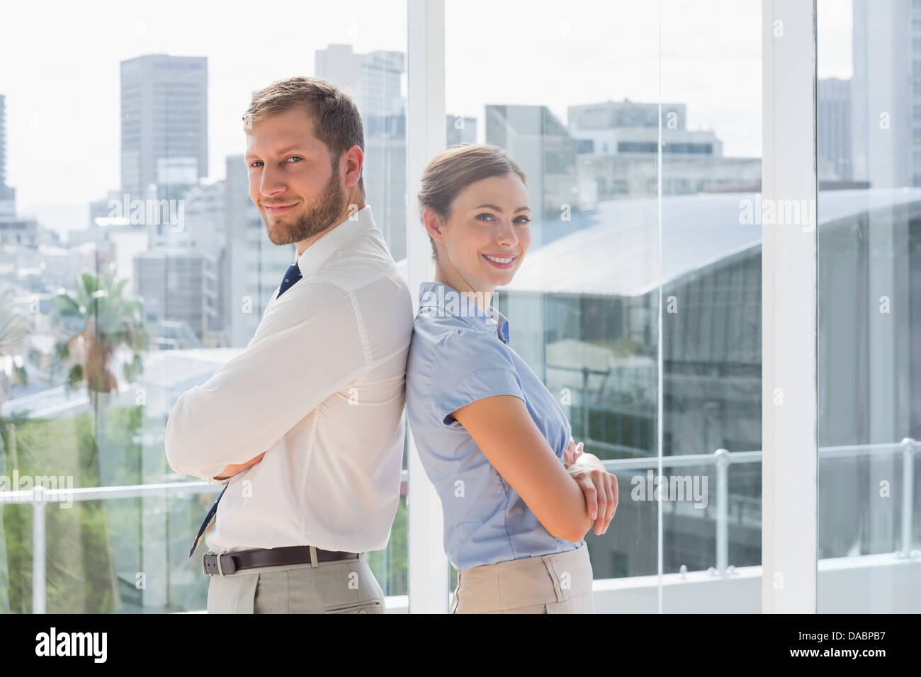 Confident business team standing back to back Stock Photo - Alamy