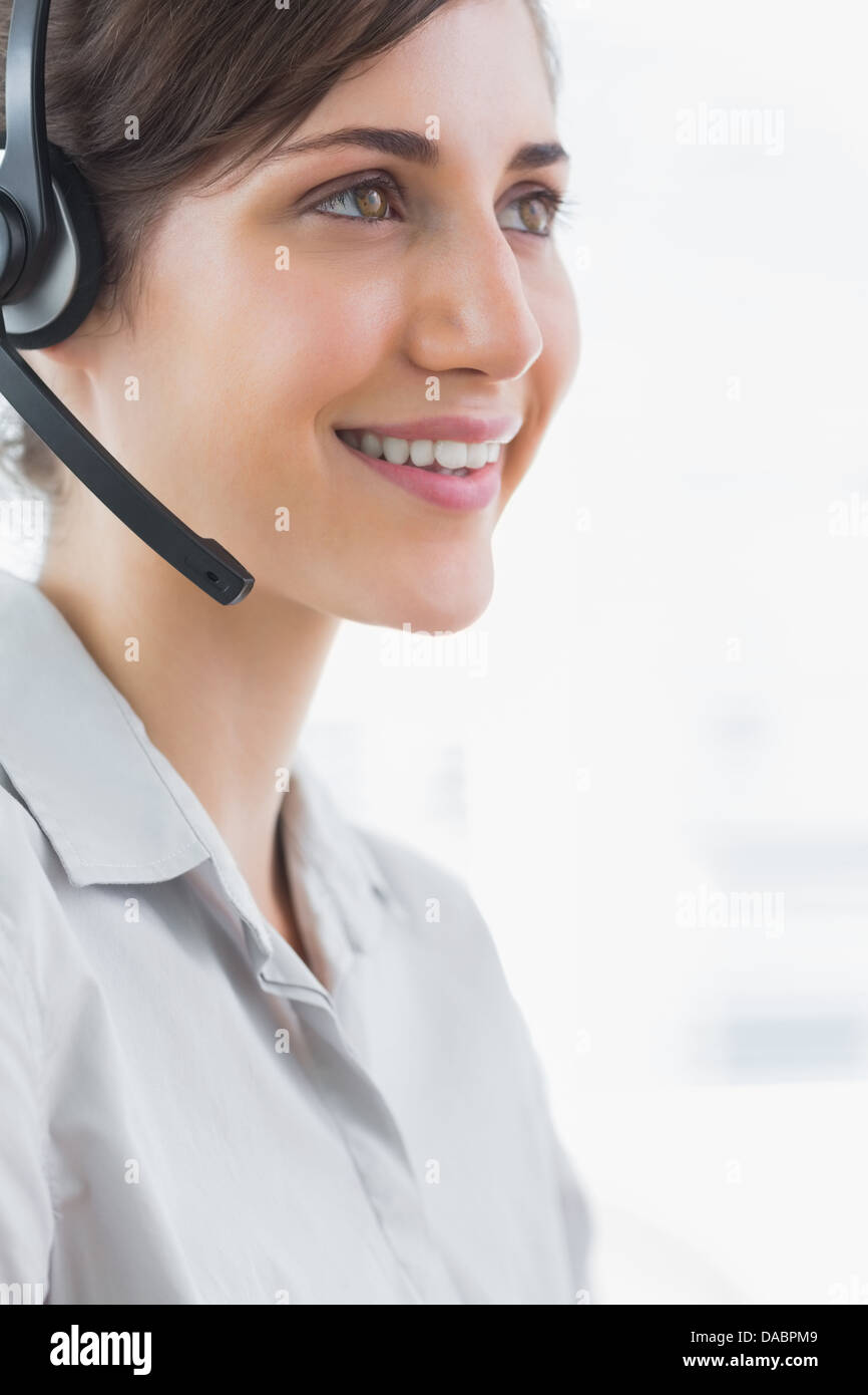 Pretty call centre agent smiling close up Stock Photo - Alamy
