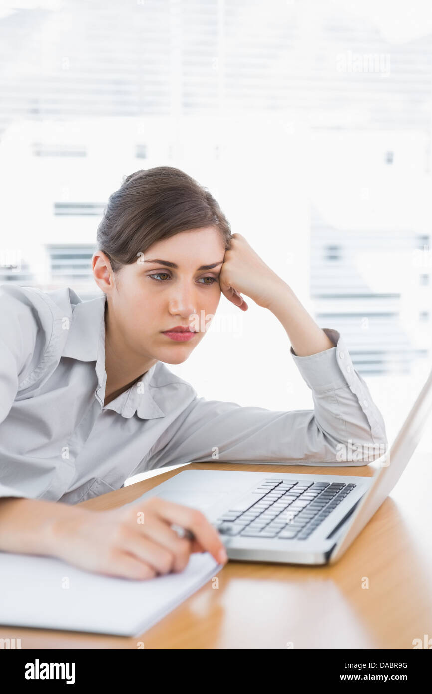 Fed up businesswoman at her desk Stock Photo - Alamy
