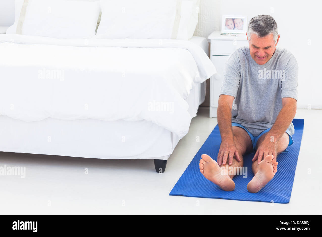 Man working out on an mat Stock Photo - Alamy