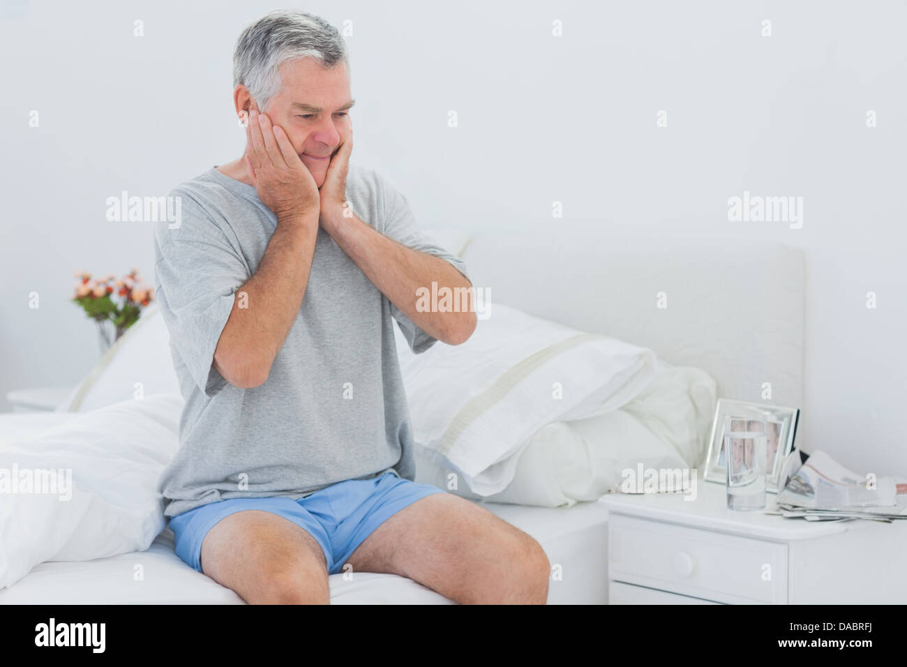 Man about to get off the bed Stock Photo - Alamy