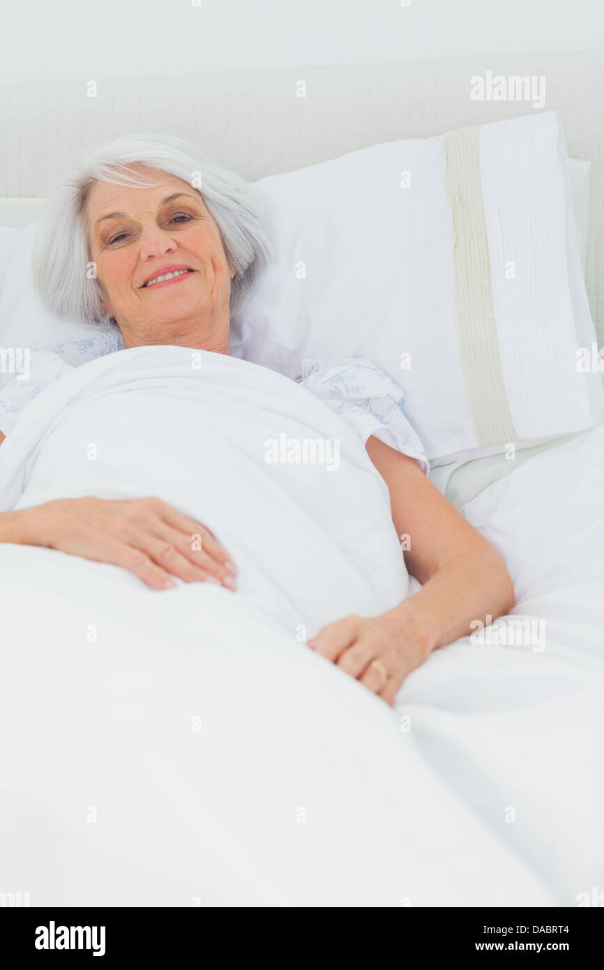 Woman resting in bed Stock Photo - Alamy