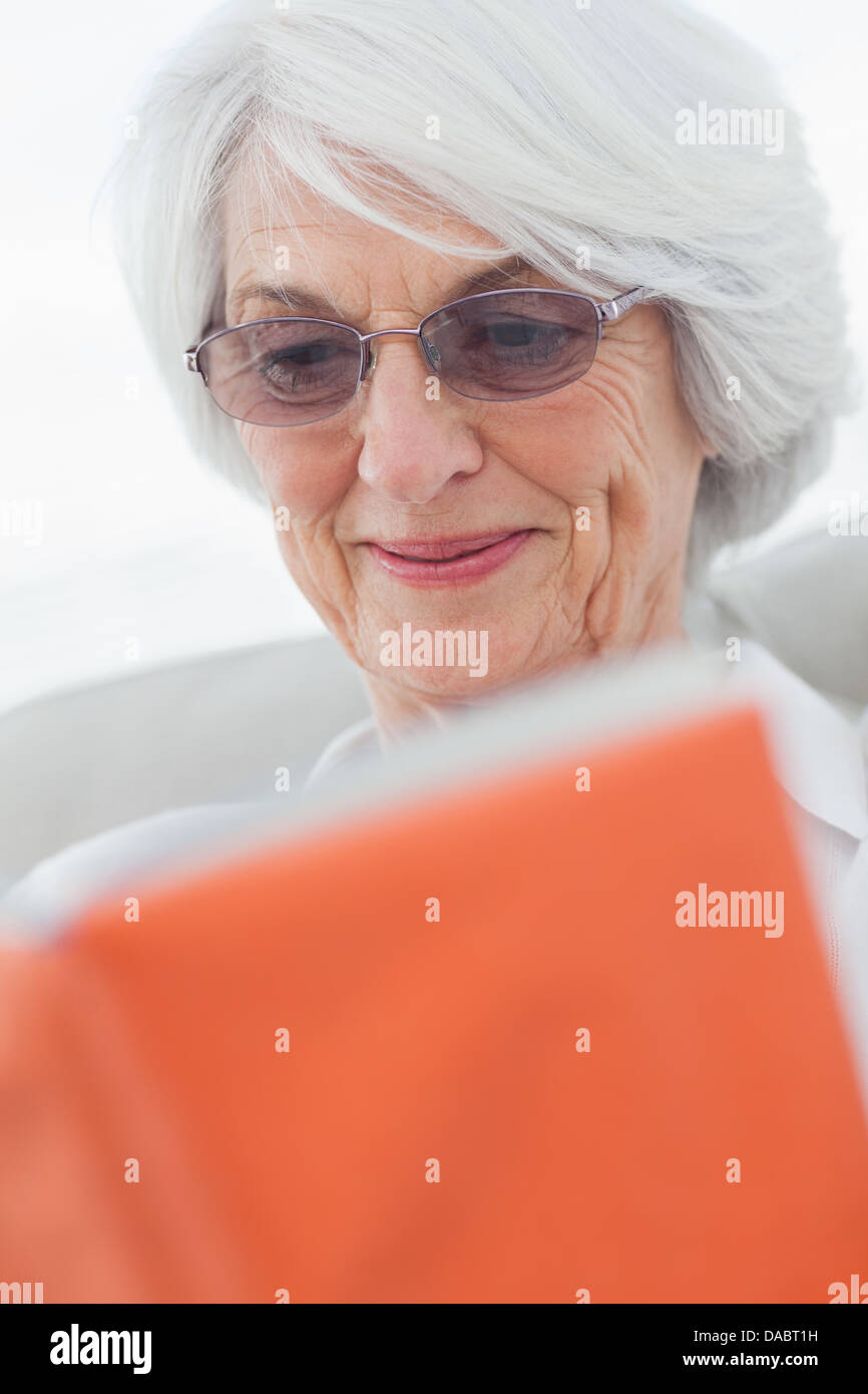 Retired woman reading a book Stock Photo - Alamy