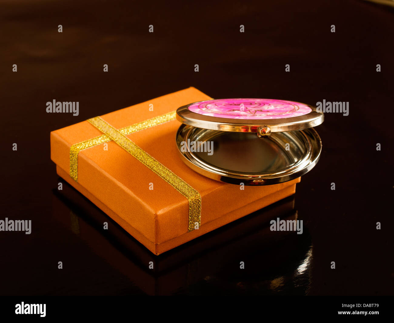 pocket mirror and yellow box on a black background Stock Photo - Alamy
