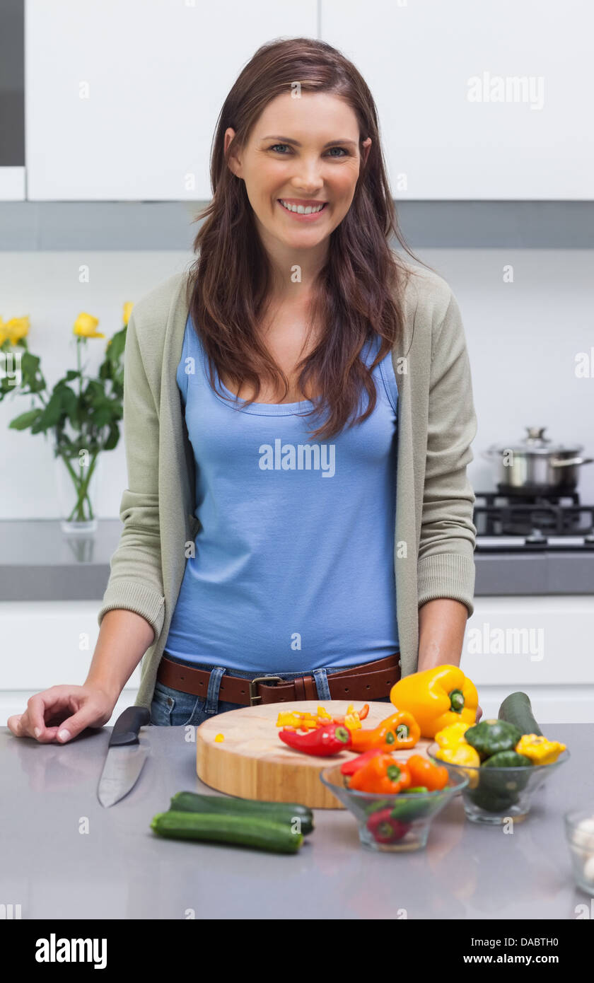 Attractive woman standing in her kitchen Stock Photo - Alamy