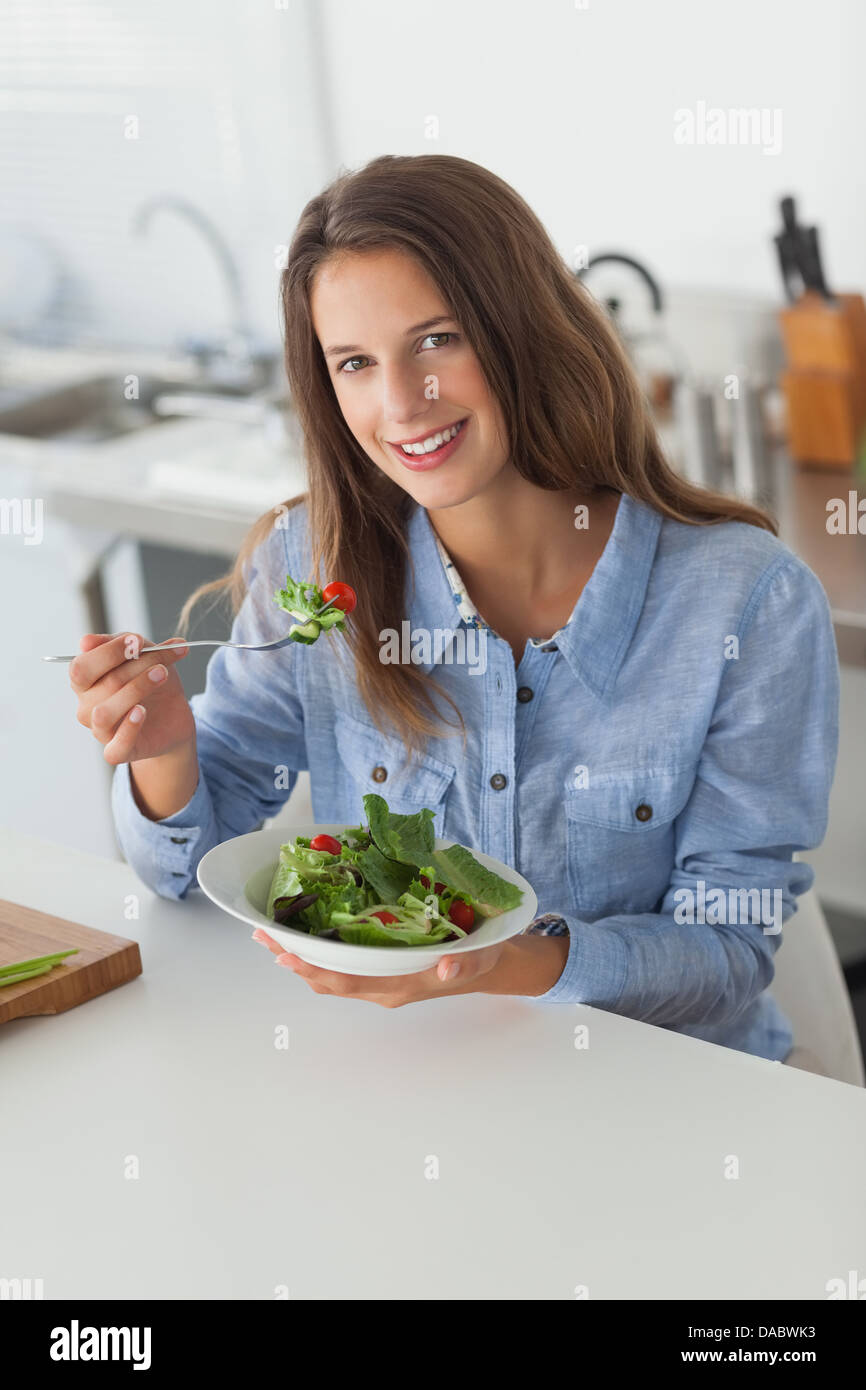 Attractive woman eating a salad Stock Photo - Alamy