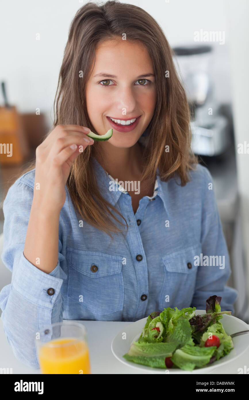 Pretty woman eating a salad with a glass of orange juice Stock Photo ...