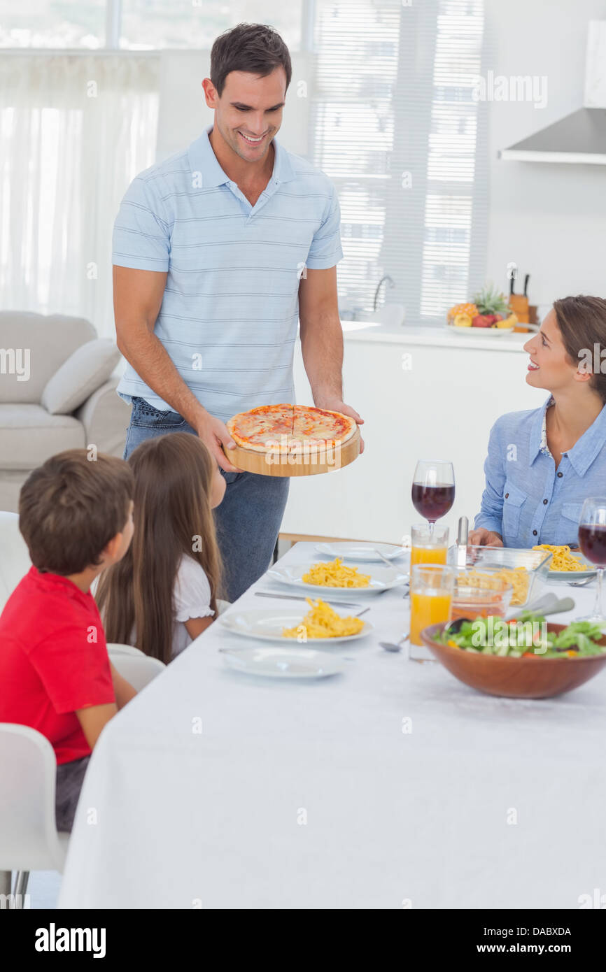 Man bringing a pizza to his family Stock Photo - Alamy