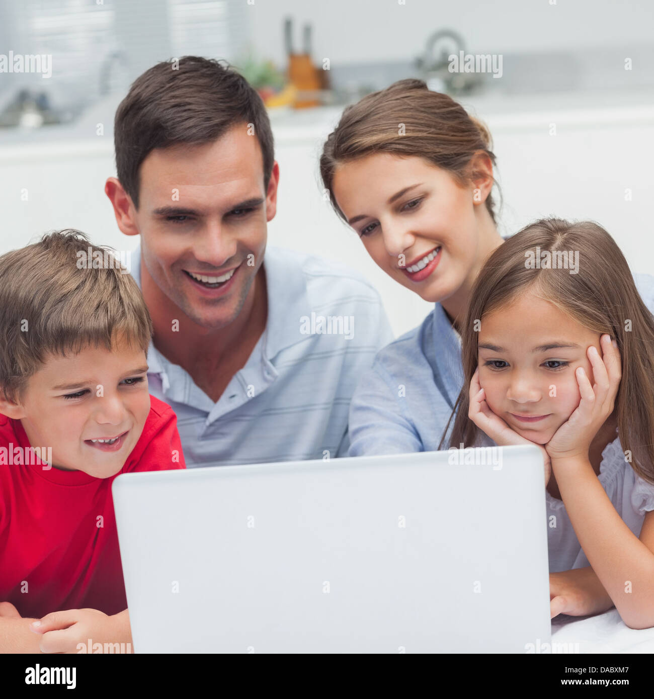Parents and children using a laptop Stock Photo - Alamy