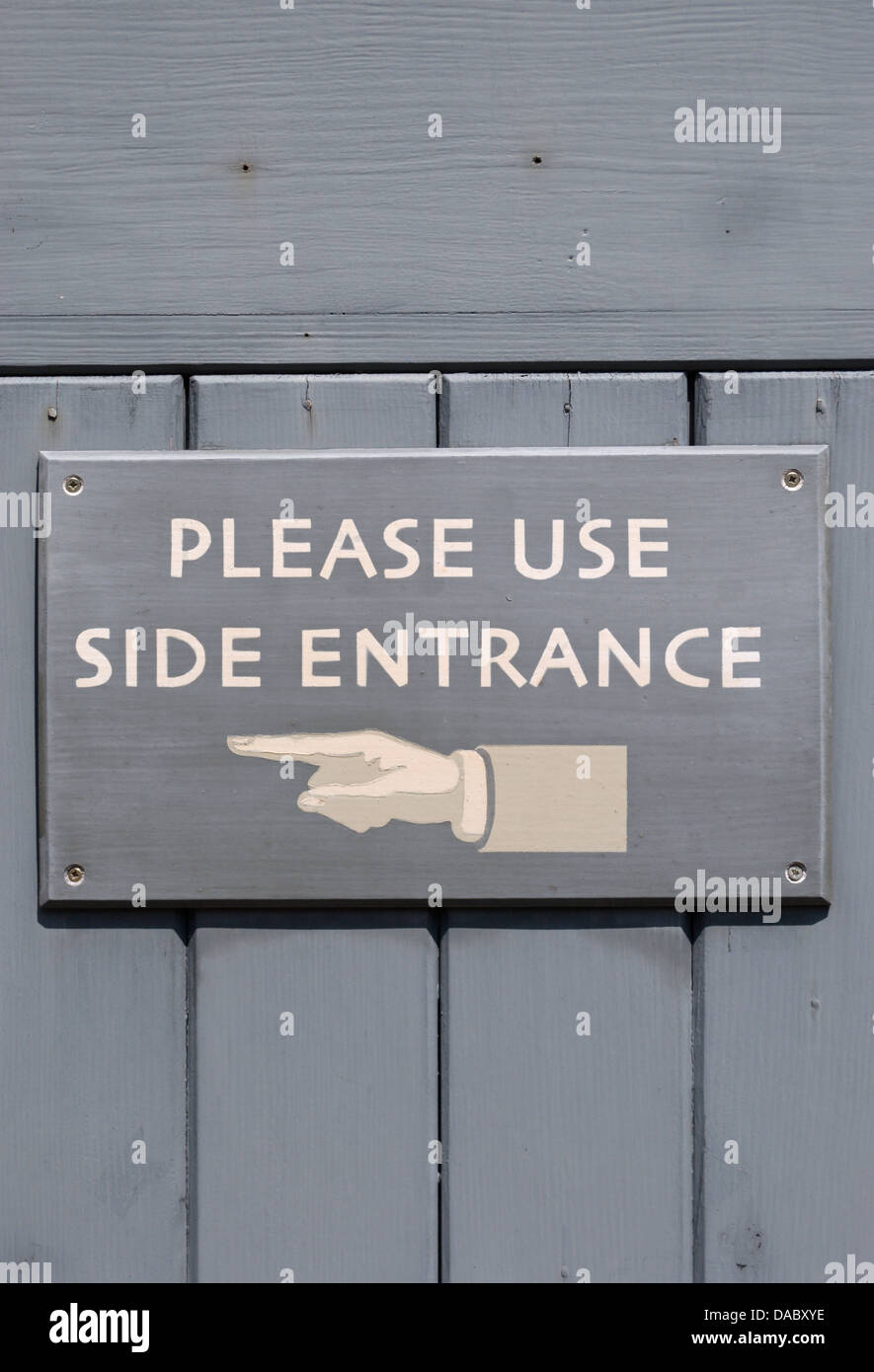 door sign stating please use side entrance Stock Photo - Alamy