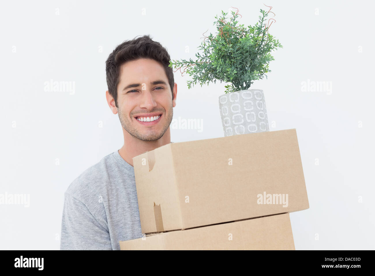 Man holding boxes because he is moving Stock Photo - Alamy