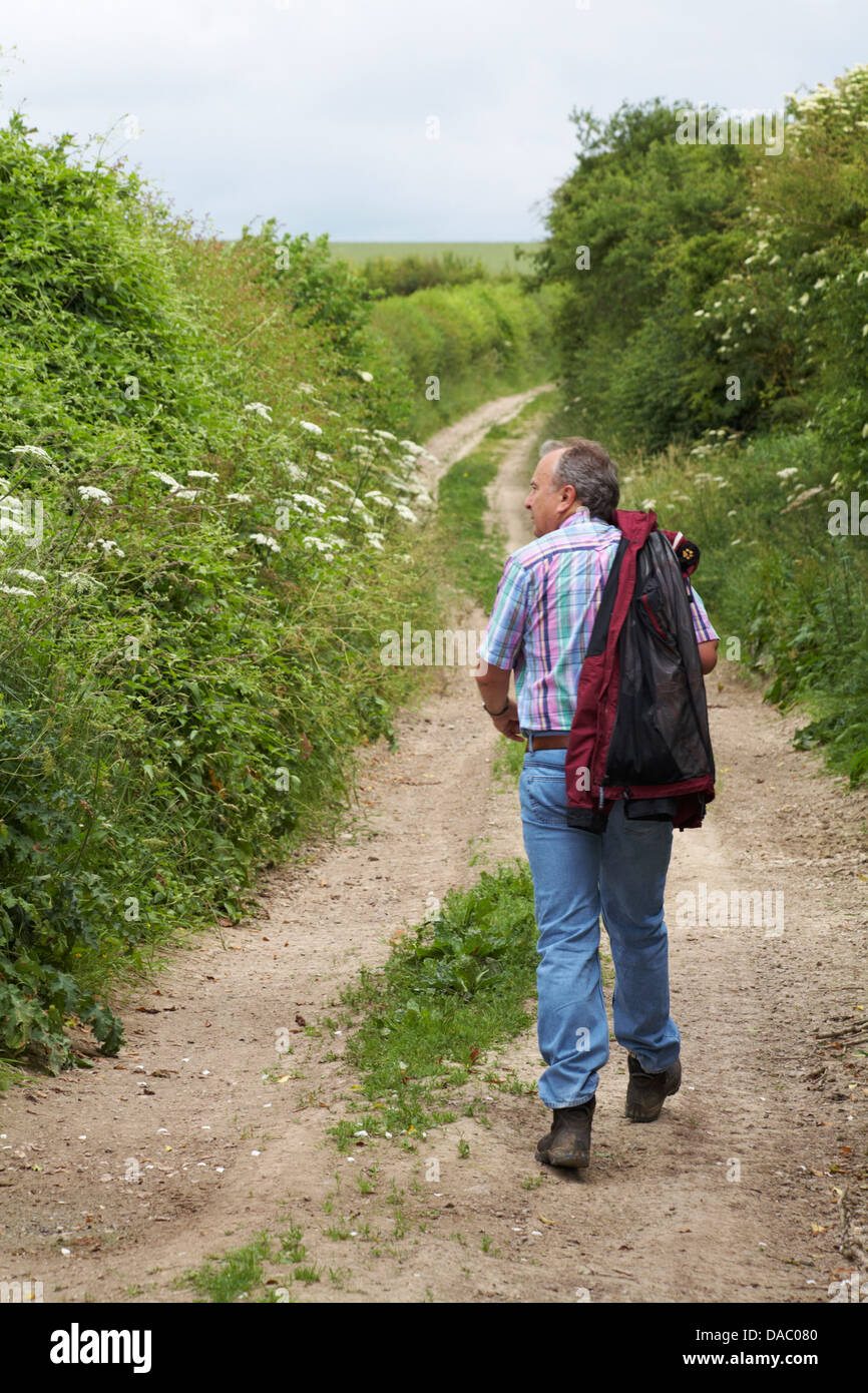 Mature man walking down country lane at Cranborne in July Stock Photo ...