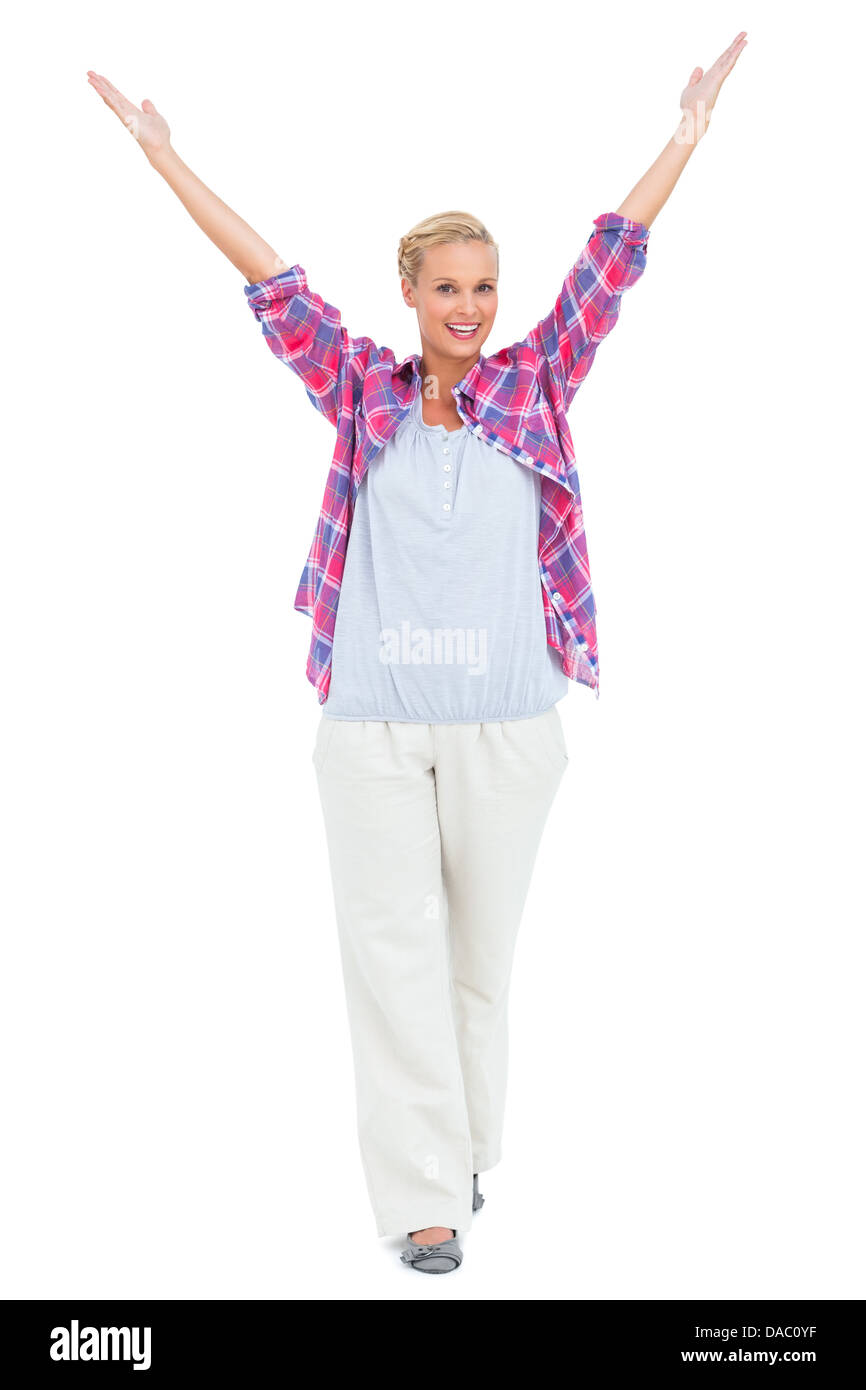 Blonde woman standing with hands up Stock Photo - Alamy