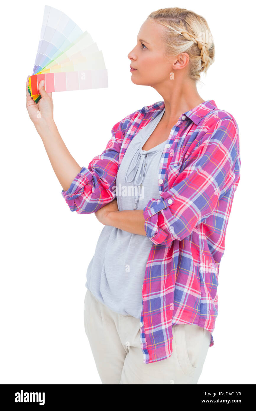 Blonde looking at colour charts and picking colour Stock Photo - Alamy