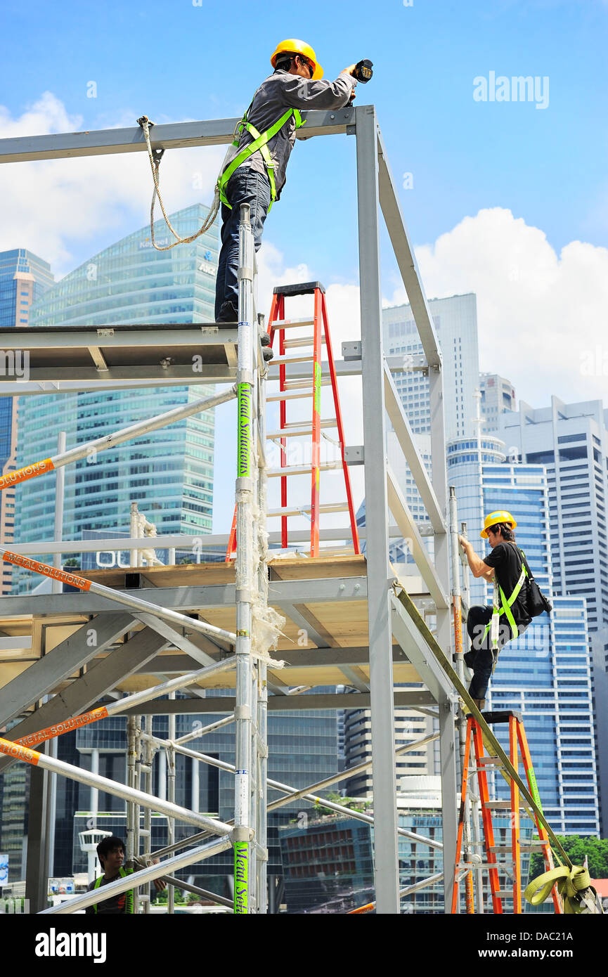 Workers at construction site in front of Singapore downtown Stock Photo ...